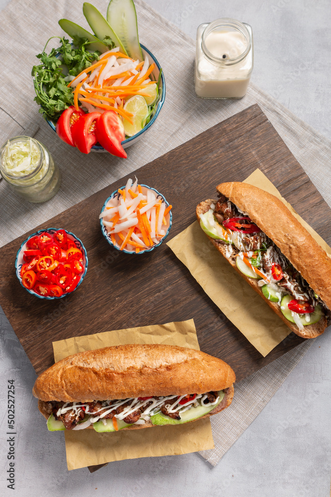 Banh Mi - Vietnamese sandwich with sausage, pork, lettuce, tomato and ...