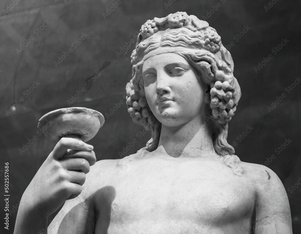 Ancient statue of Dionysus isolated on a white background. Dionysus is ...