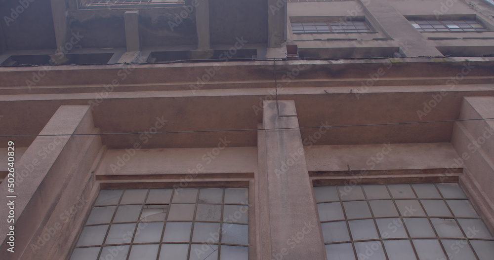 Facade of an industrial building with windows, rectangles and glass ...
