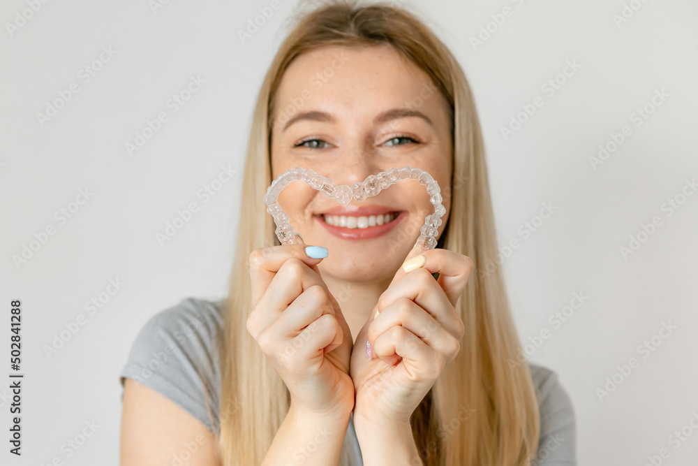 Woman with perfect smile after invisible invisalign aligners treatment ...