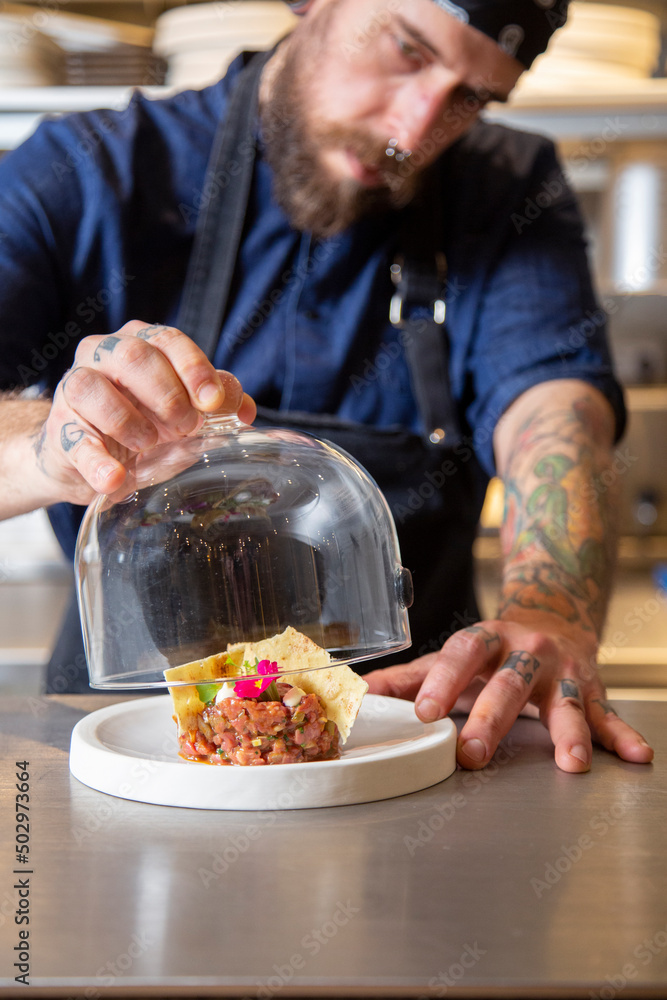 Chef covering tartare with glass dome Stock Photo | Adobe Stock