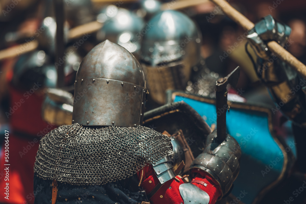 Pitch battle of medieval knights, using metal armor, axes, swords and ...