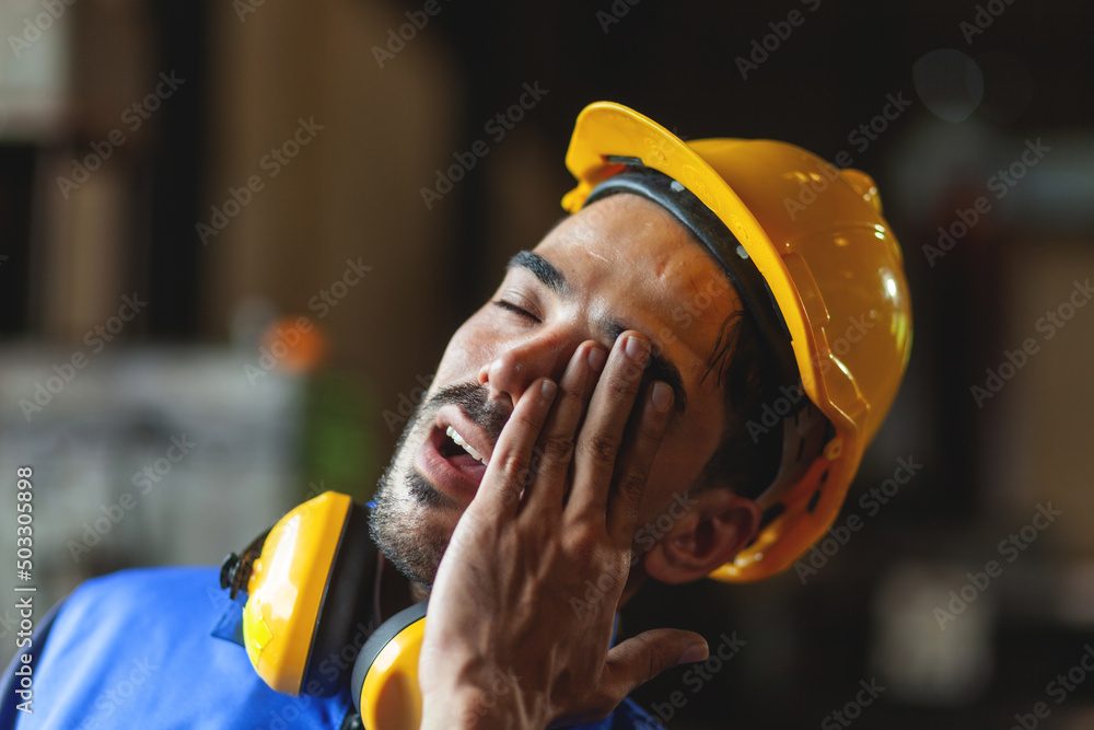 Close-up of a worker having an eye accident in a metal lathe factory ...