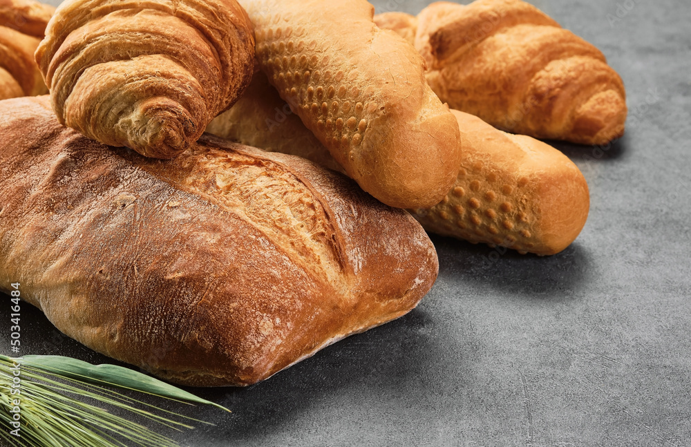 Different kinds of bread rolls on gray board, closeup. Kitchen or ...