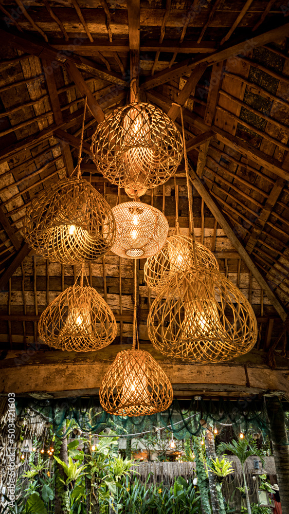 Traditional Bali style wicker lamp in the restaurant in Bali, Indonesia ...