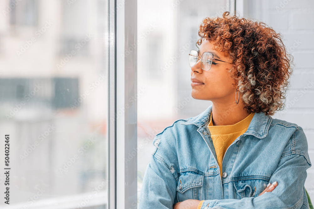 pensive girl or woman looking out the window Stock Photo | Adobe Stock