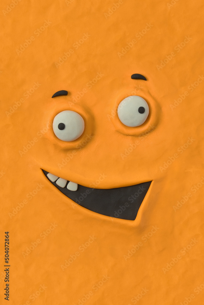 Ugly-eyed monster, fabulous creature made by hand from orange ...