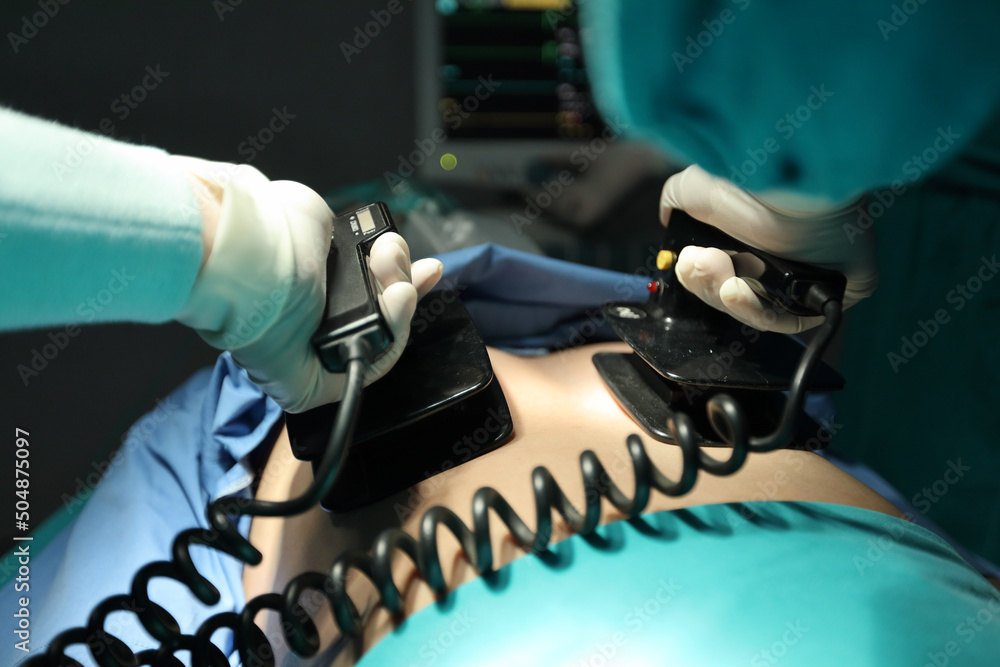 Closeup image of professional concentrated surgical team performing CPR ...