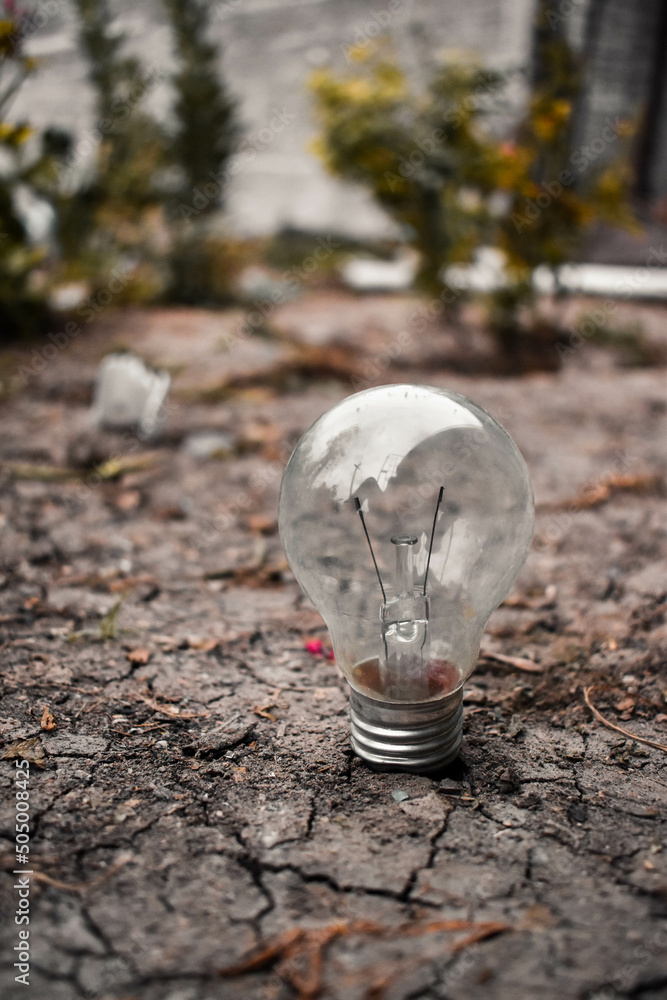 Light bulb buried in dry land in the form of global warming Stock Photo ...