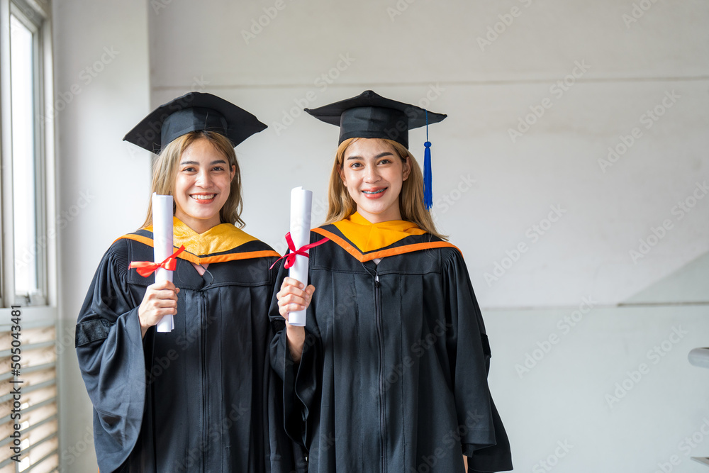 Student holding diploma degree certificate scroll during commencement ...