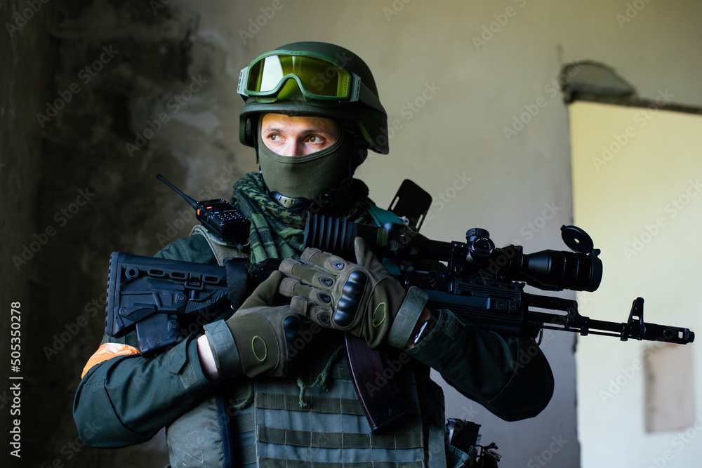 Ukrainian military sniper militant stands by the window. special forces ...