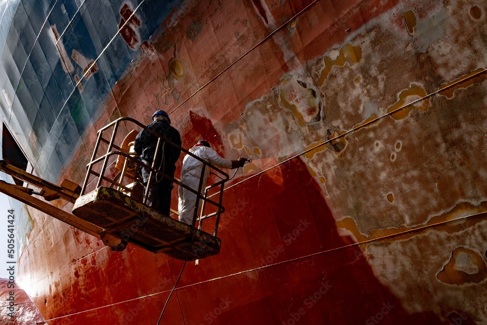 Workers working in a shipyard and painting in naval industry Stock ...