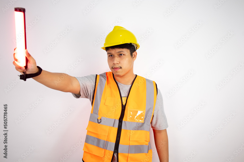 Construction workers give a stop signal by a lightstick in work clothes ...