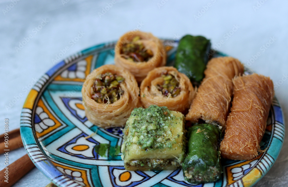 Arabian sweets on a plate. Traditional pastries made of pistachio and ...
