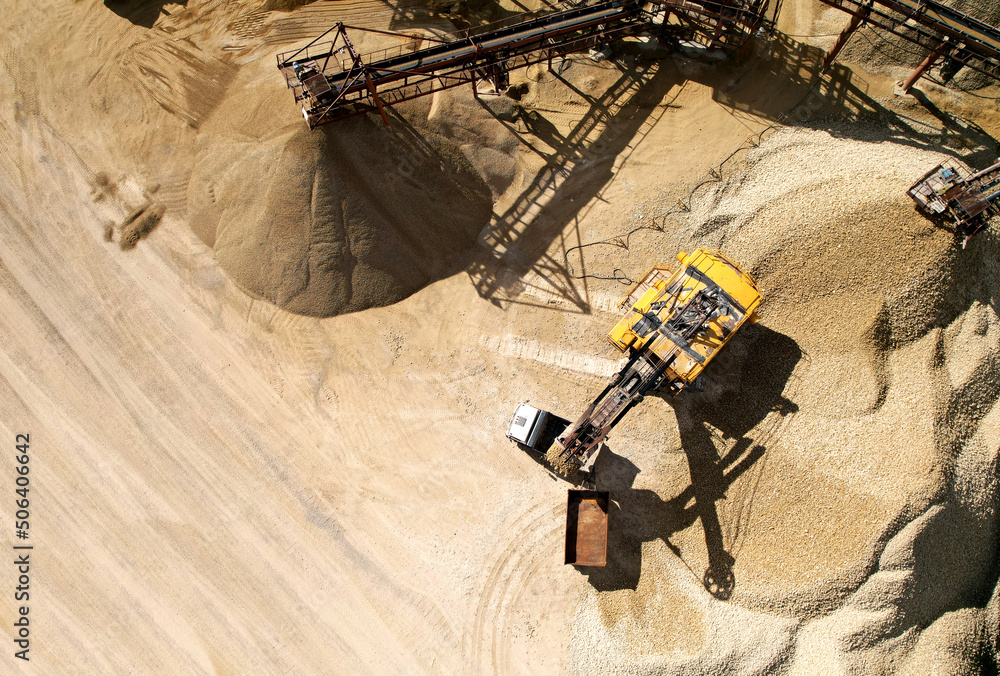 Mining excavator with electric shovel loading sand into haul truck in ...