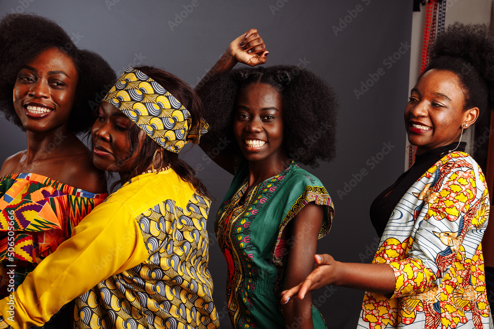 Four young beautiful African fashion models have fun and laughing in ...