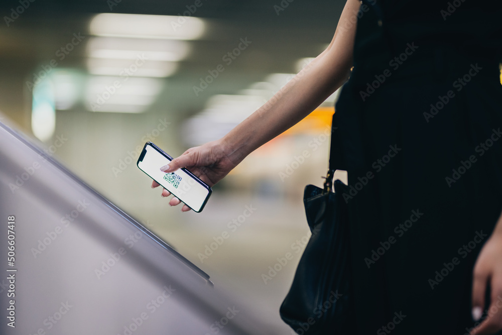 Photo Stock Cropped shot of young Asian woman scanning QR code ...