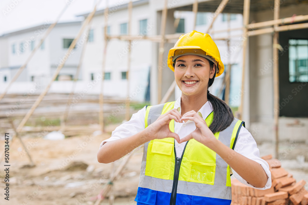 beauty woman hand love sign dressing as engineer worker builder in ...