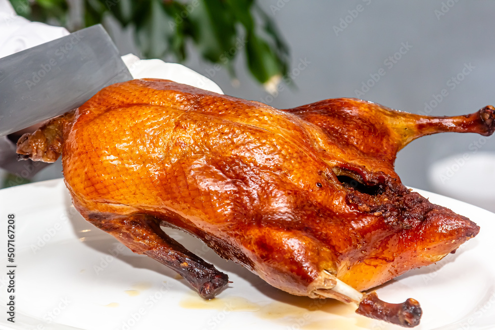 Chinese cook prepares beijing Roast Duck. Peking Duck is a famous duck ...