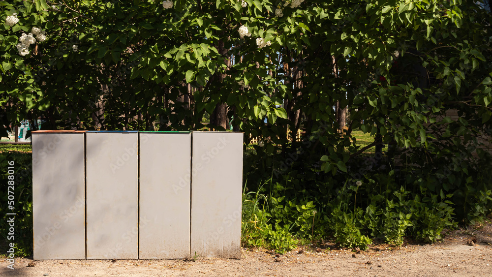 Containers for separate waste collection in park. Waste sorting on walk ...