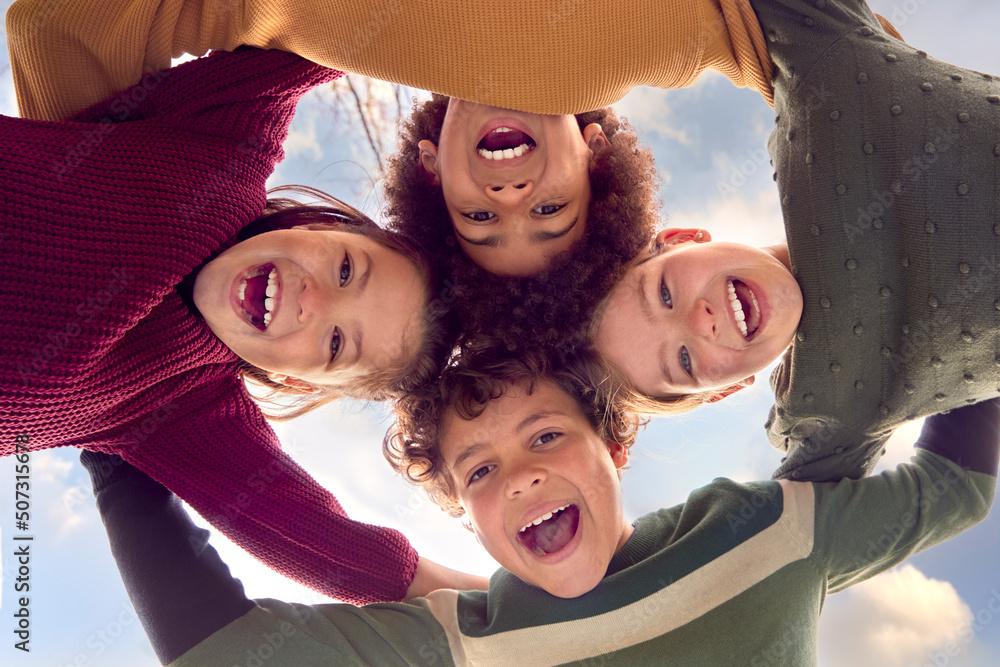 Low Angle Portrait Of Children Having Fun Playing Outdoors Linking Arms ...