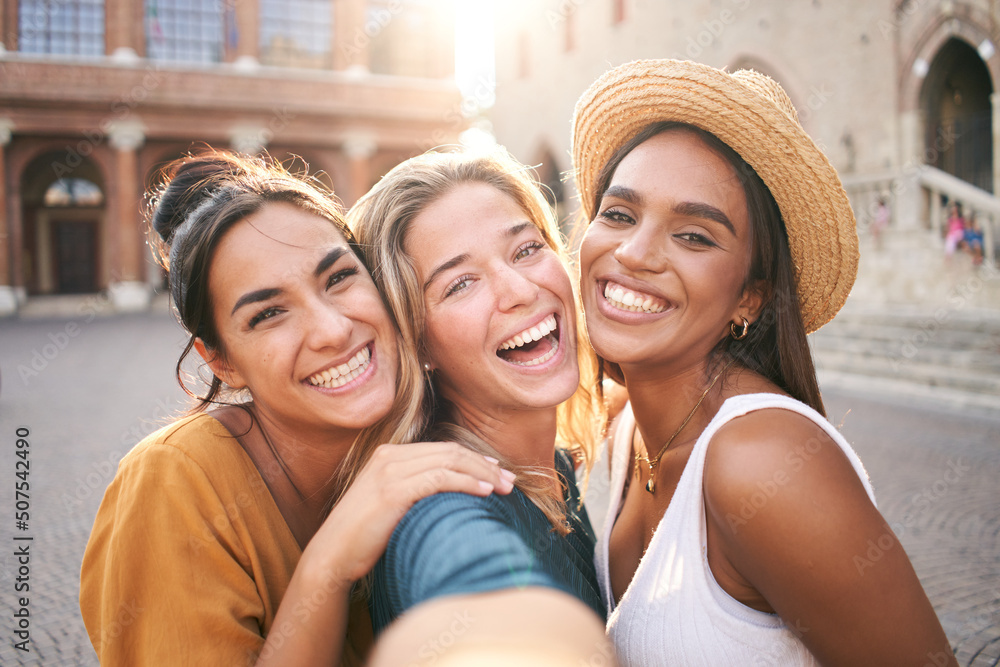 Three young smiling hipster women in summer clothes. Girls taking ...