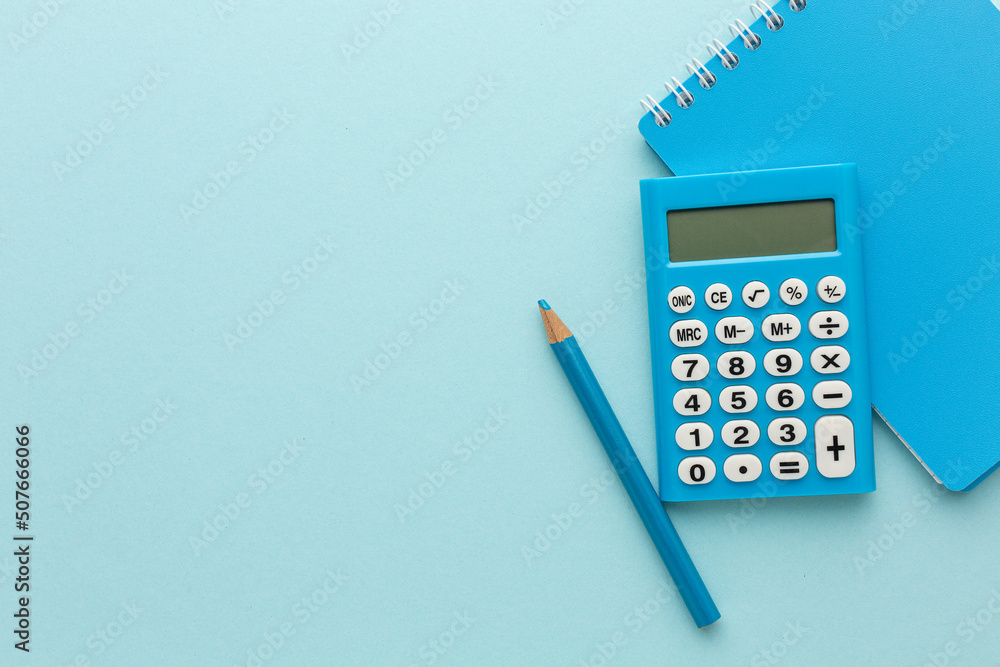blue calculator on a colored background Stock Photo | Adobe Stock
