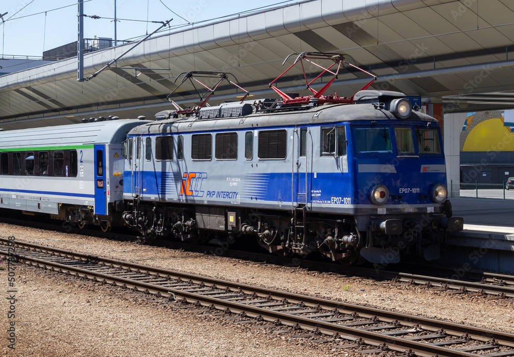 PKP Intercity EP07 electric locomotive with passenger cars. Polish state railways long-distance ...