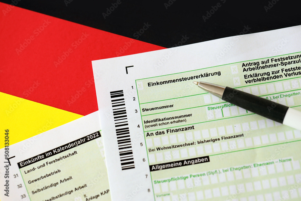 German annual income tax return declaration form with pen on flag close ...