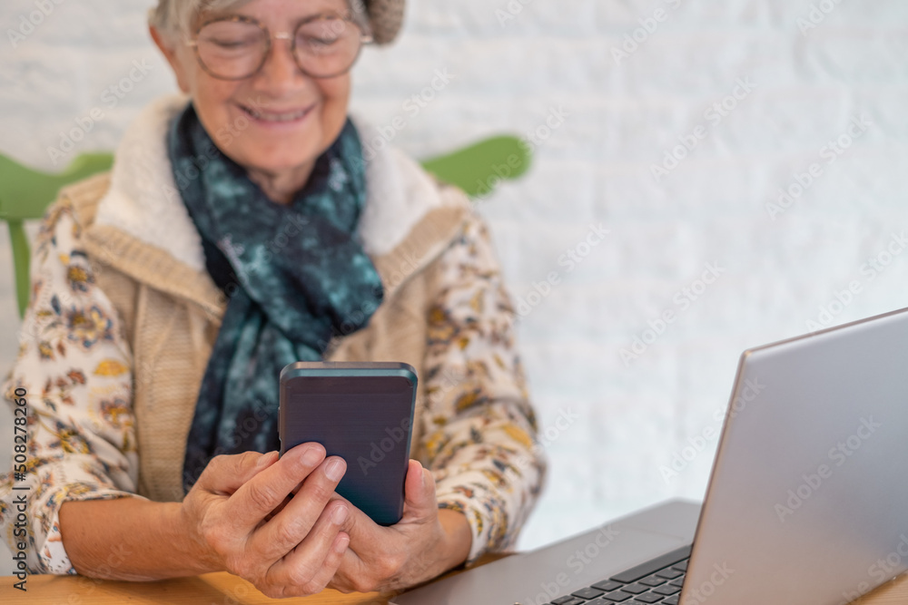 Beautiful caucasian senior woman reading text message on mobile phone ...