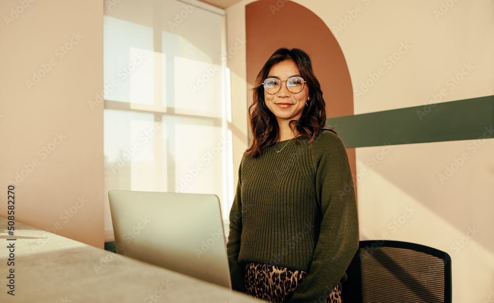 Cheerful receptionist standing at the front desk Stock Photo | Adobe Stock