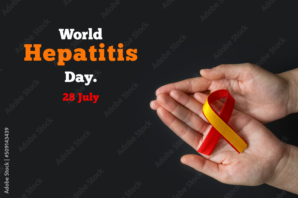 World hepatitis day. Adult hands holding red yellow ribbon on black ...