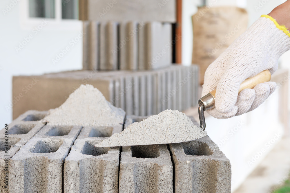 Cement or mortar, Cement mix with a trowel in a hand on the brick for ...