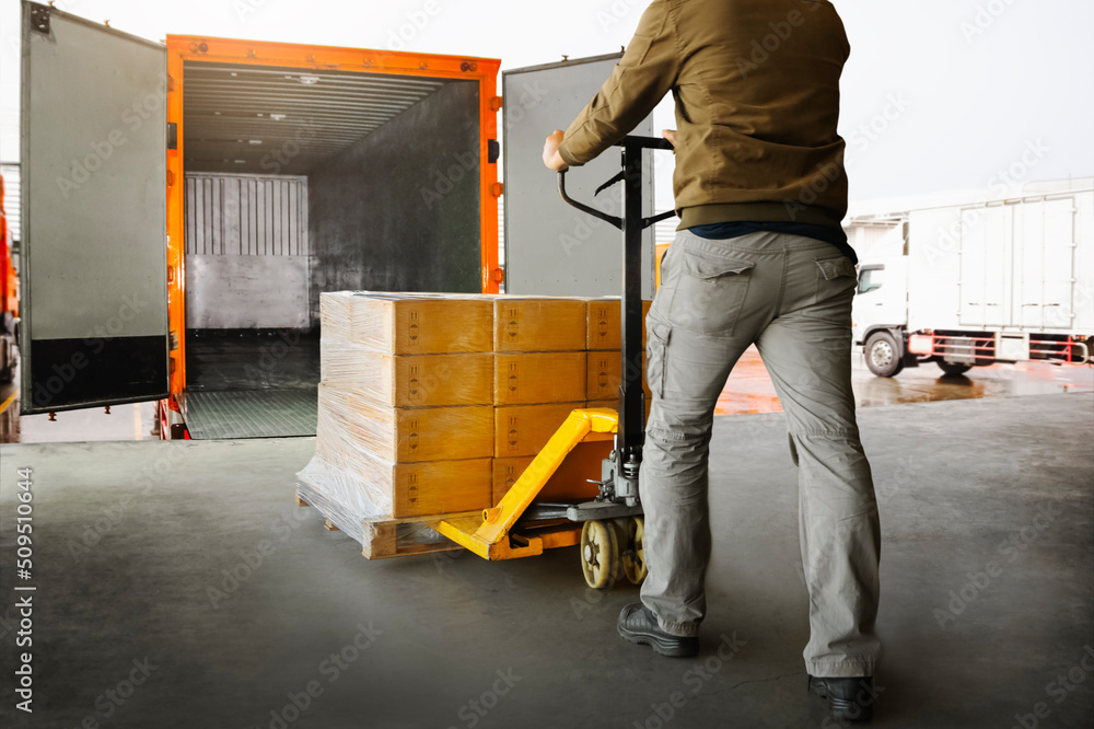 Стокове фото Workers Unloading Packaging Boxes on Pallets into The ...