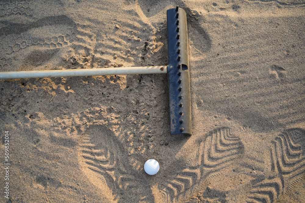 Golf concept. Golf ball and rake sand on bunker in beautiful golf ...
