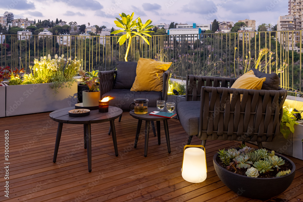 Amazing sun terrace with sofa armchairs, coffee tables, flower pots ...