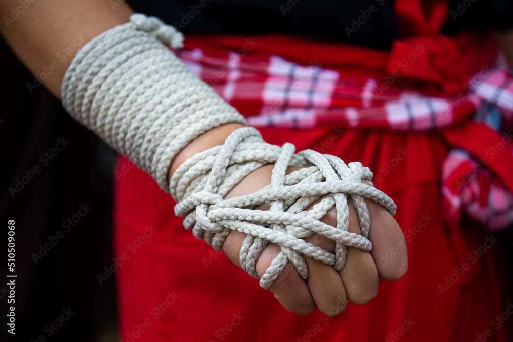 Close up hand wrapping by rope, the Muay Thai Boran or Muay Thai Kard ...