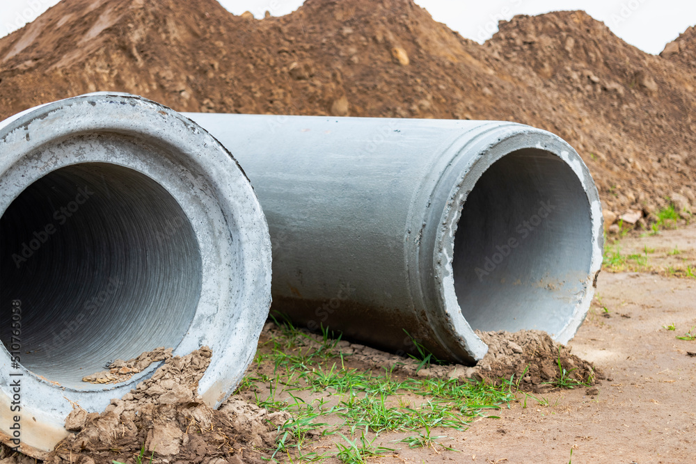 Reinforced concrete storm sewer pipes of large diameter stacked at a ...