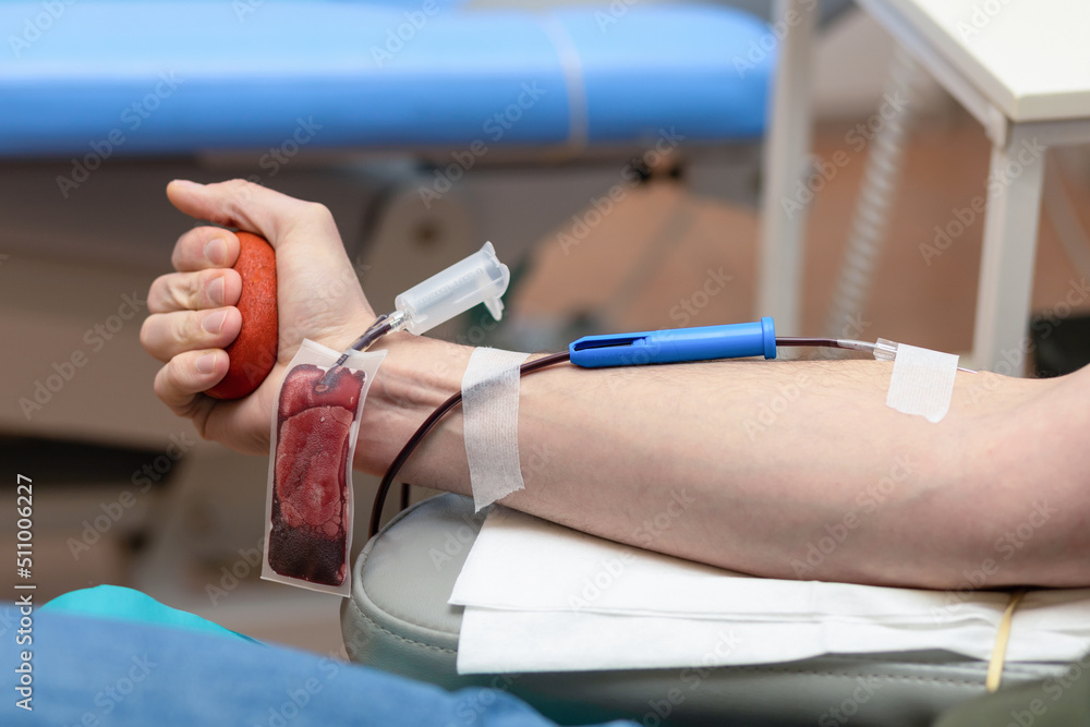 bone marrow donation. male hand holding red ball, man with blood ...