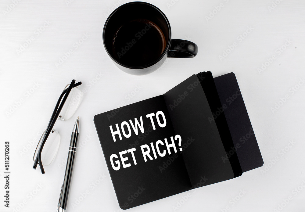 HOW TO GET RICH written text in small black notebook with coffee , pen ...