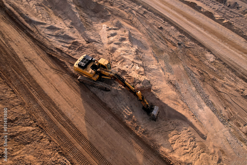 Excavator dig ground at construction site. Earthmover on road construction. Heavy equipment and ...