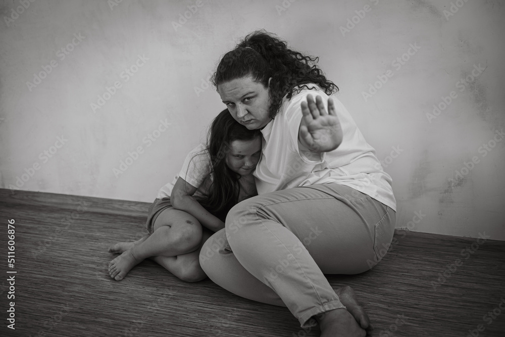 Black and white portrait of abused family. Young scared mother woman ...