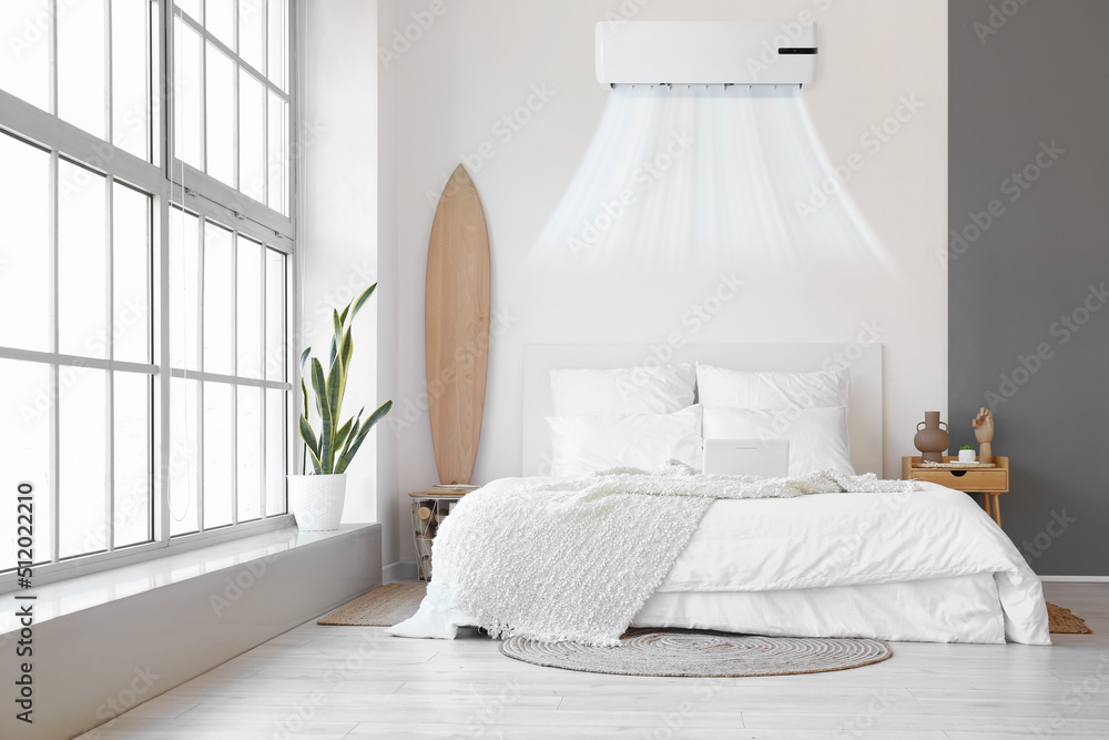 Interior of modern bedroom with operating air conditioner Stock Photo ...
