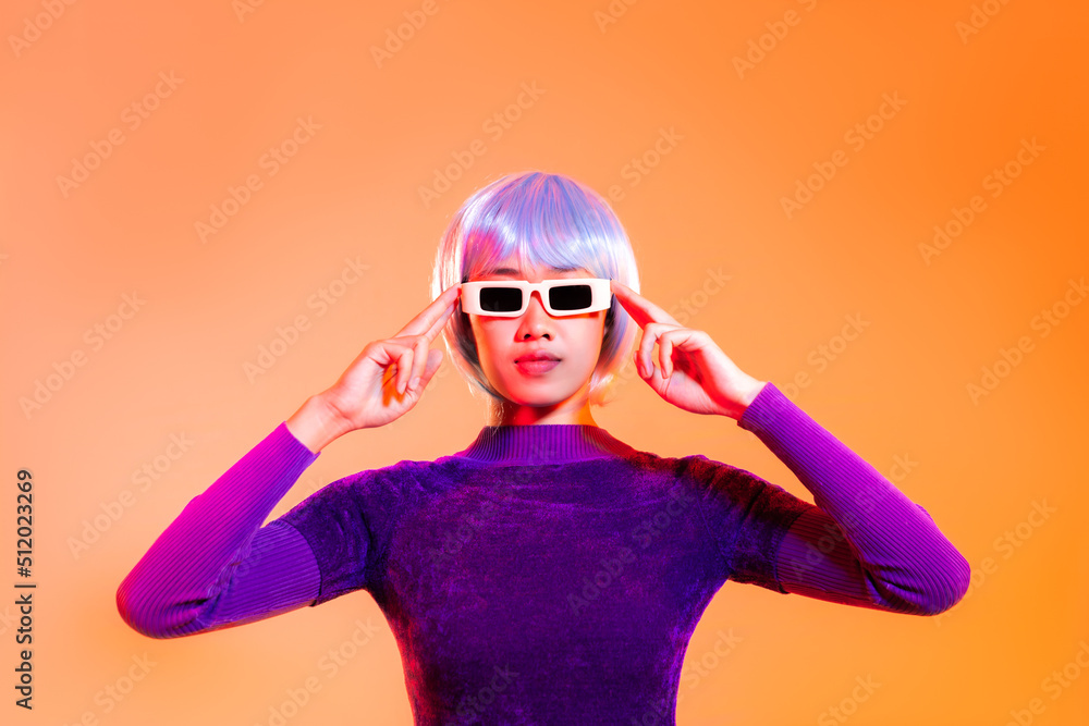 Metaverse concept. Young asian girl in purple shirt wearing sunglasses ...