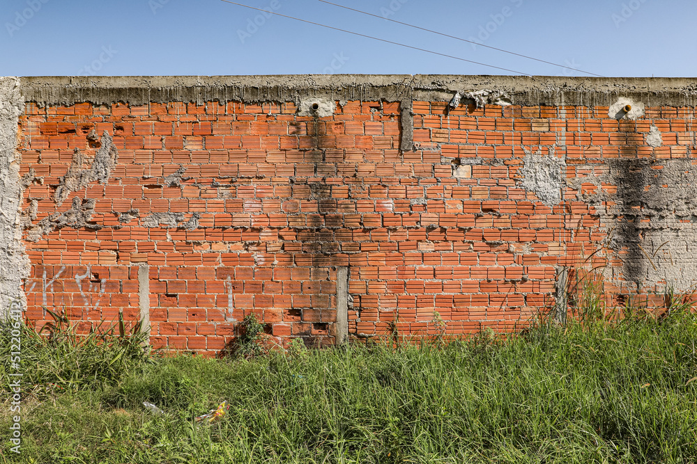 Wall mute with plaster and some exposed bricks, with signs of time ...
