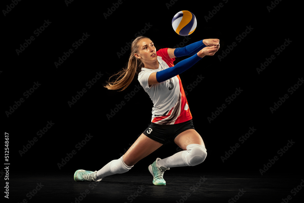 Dynamic portrait of professional volleyball player in sports uniform ...