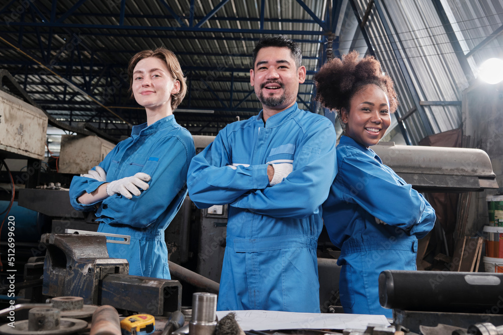 Multiracial industry workers in safety uniforms collaborate with unity ...