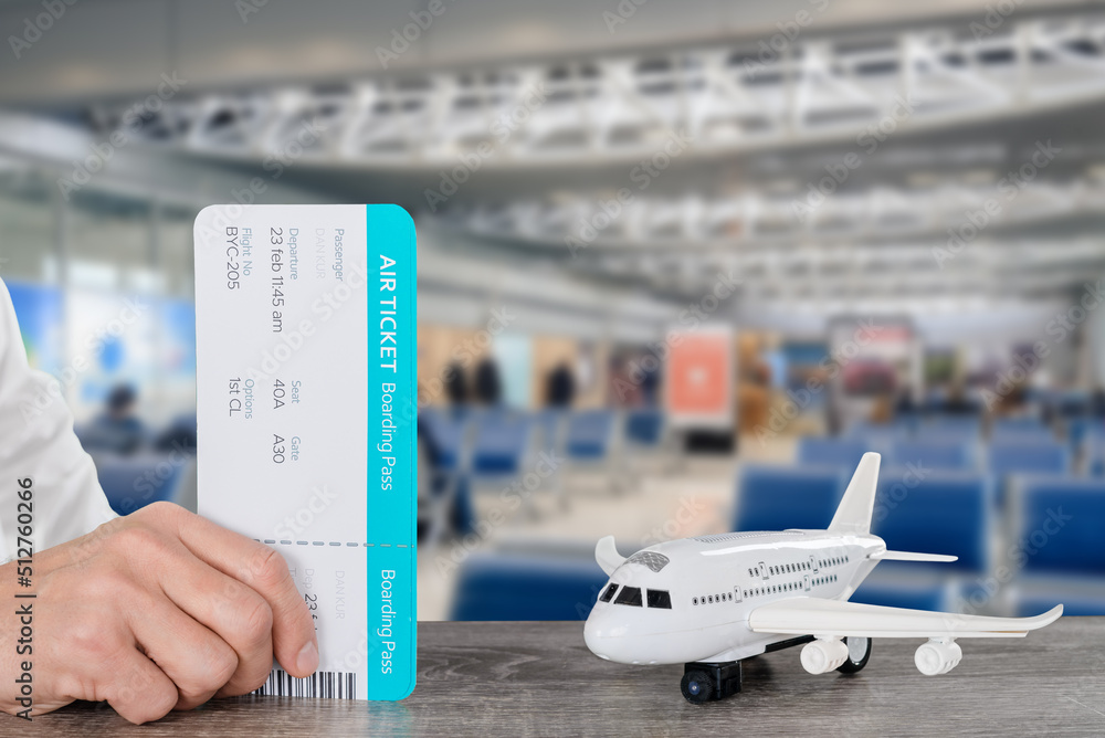 Man traveler holding airline boarding pass while waiting plane in ...