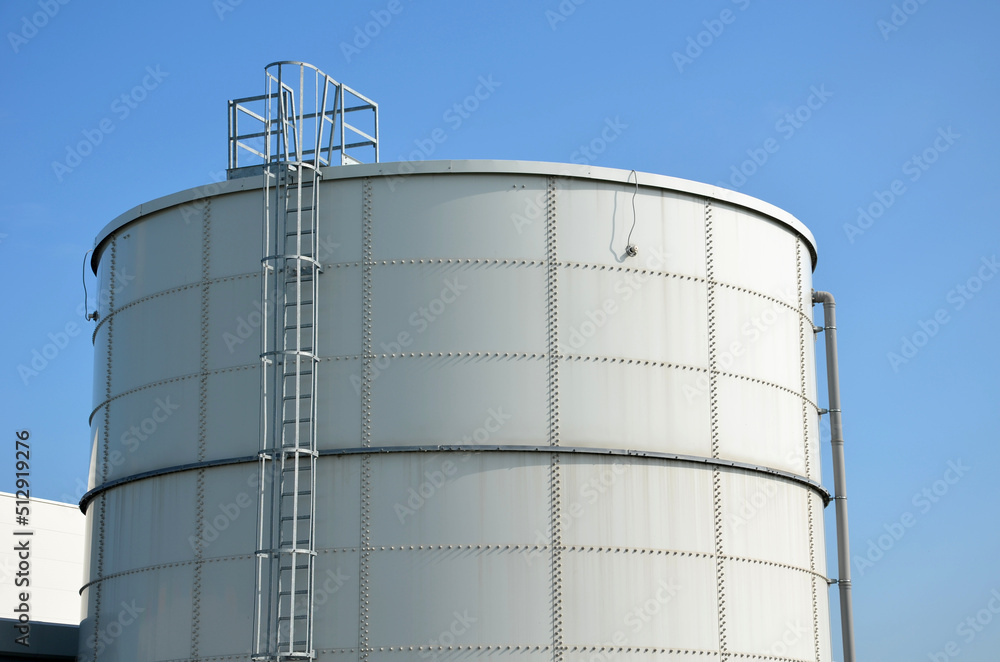 the fire ladder leading to the roof of the hall. cylindrical water tank ...