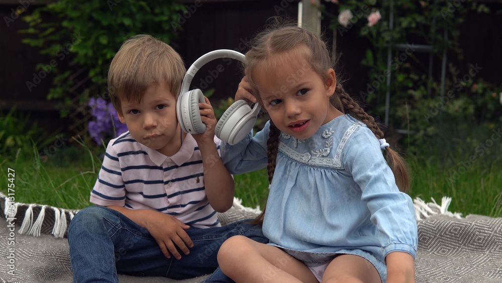 Two Happy Siblings boy ans girl listening to music on headphones ...